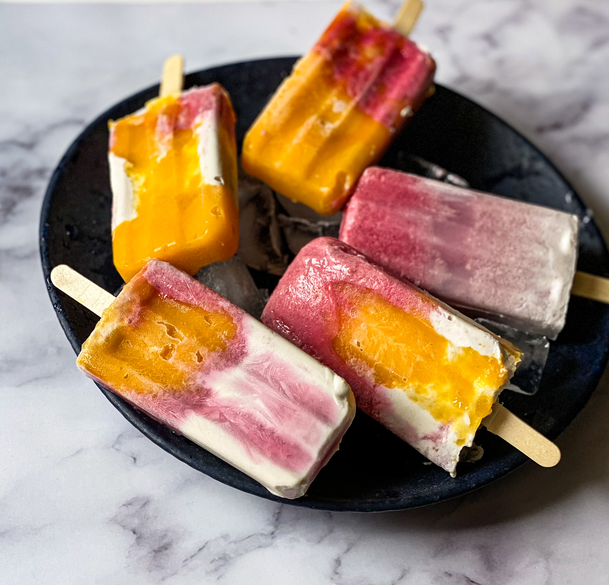 Mango and Raspberry Swirl Popsicles | Crisp and Crumble
